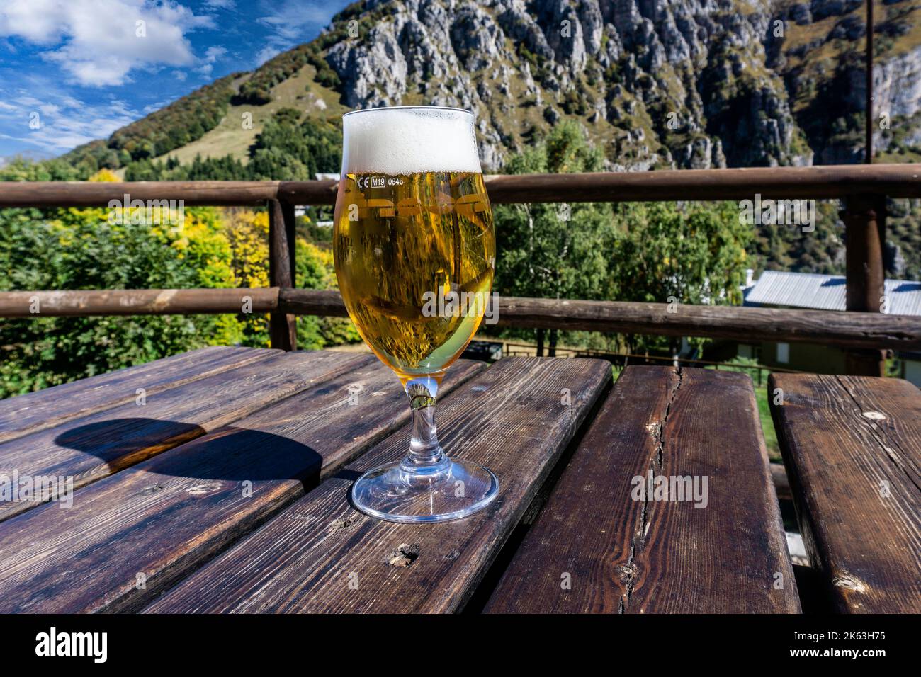 A glass of beer on a table at a restaurant at Piani D’erna 1375m above ...