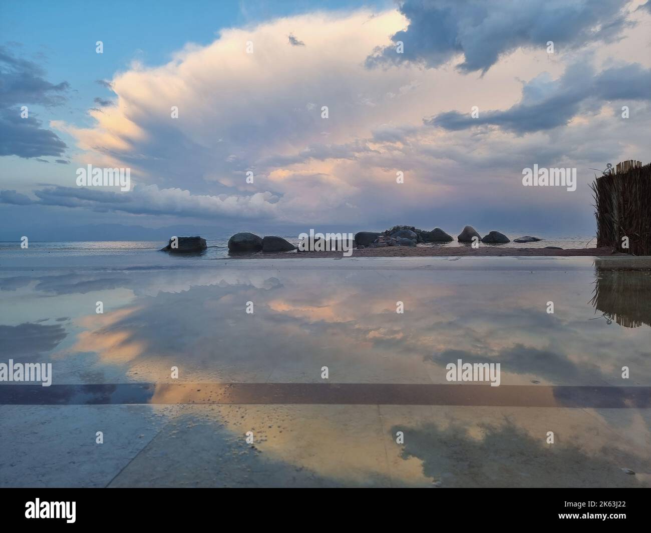 Calm on the Red Sea after rain, clouds are reflected in the surface of ...