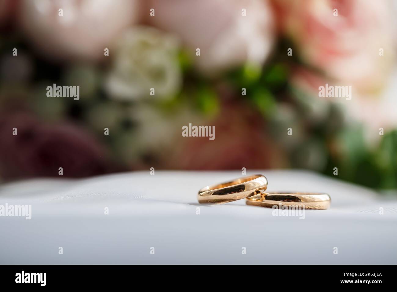 Gold wedding rings for newlyweds on wedding day Stock Photo - Alamy