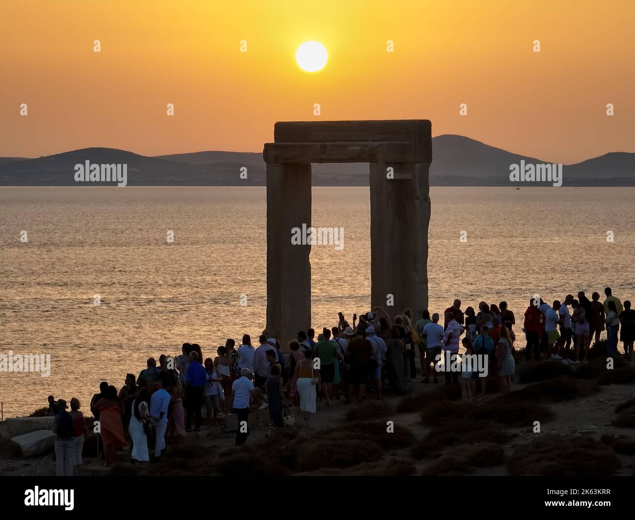 A large crowd of tourists around the famous Portara of Naxos Stock ...