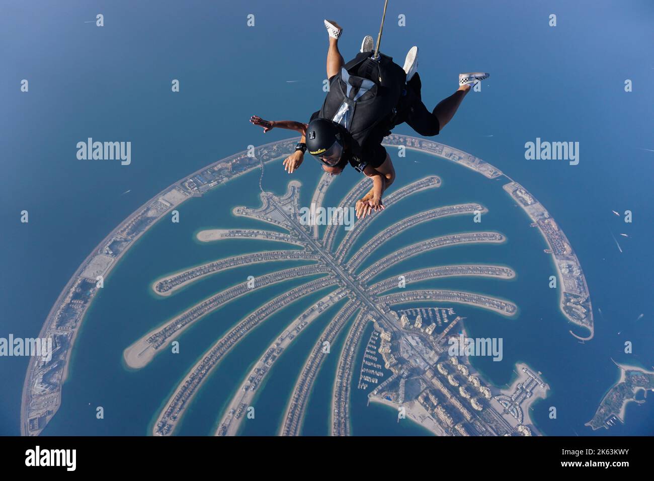 Tandem skydivers hover over Palm Jumeirah, a famous man-made island, a ...