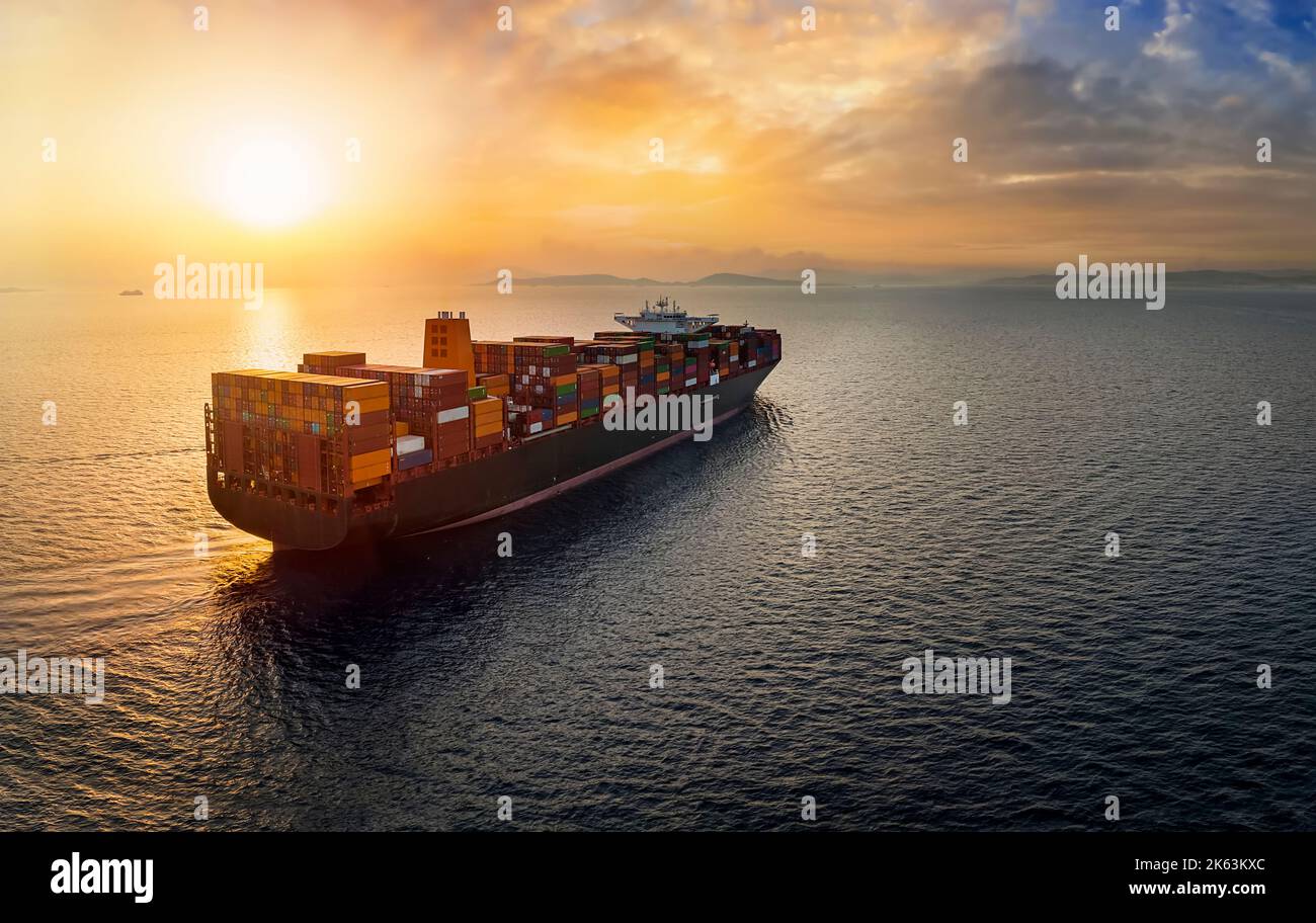 Aerial sunset view of a large, heavy loaded container cargo ship Stock ...