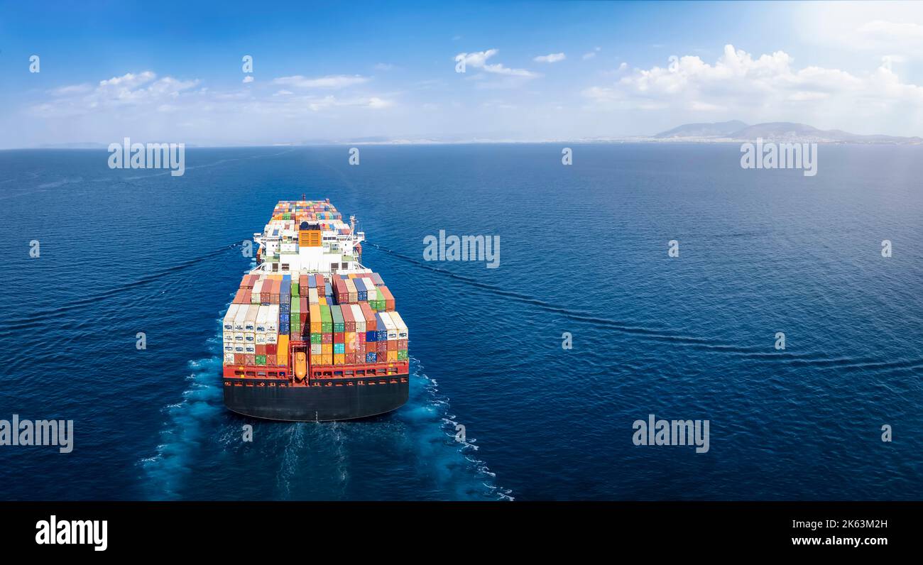 Panoramic back view of a cargo ship carrying containers for import and export Stock Photo - Alamy