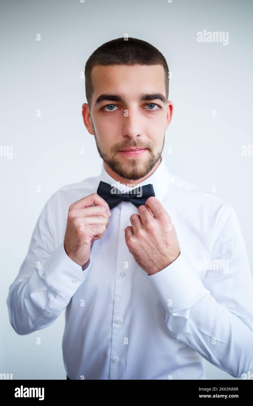 Young male businessman dressed in a white shirt with a short beard ...