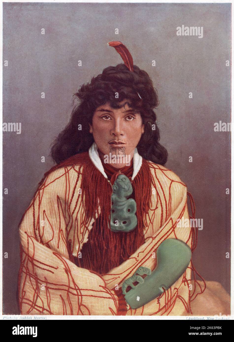 Maori woman in traditional dress, with a greenstone ornament and a club ...