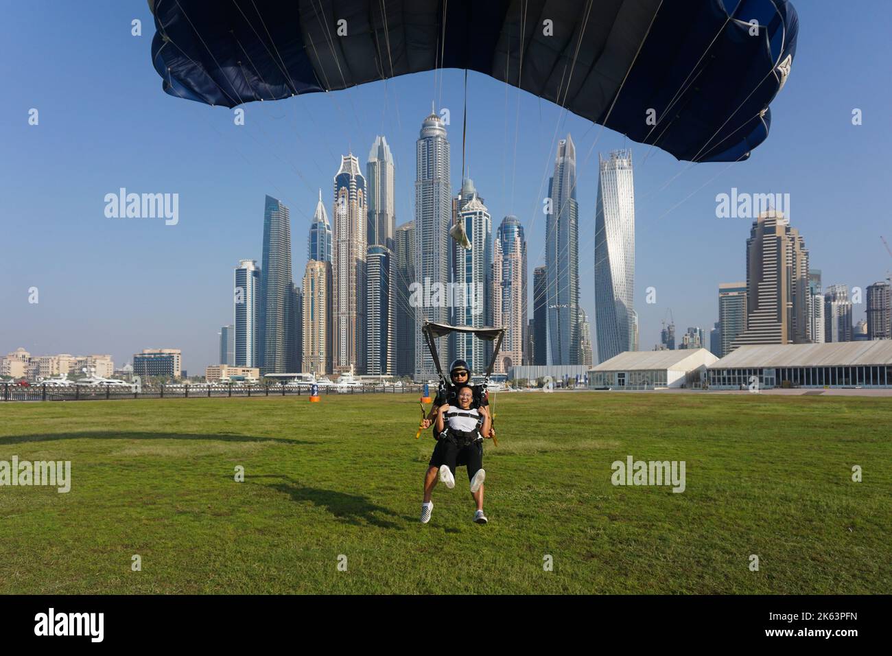 Dubai, United Arab Emirates - tandem skydivers prepare to land back to ...