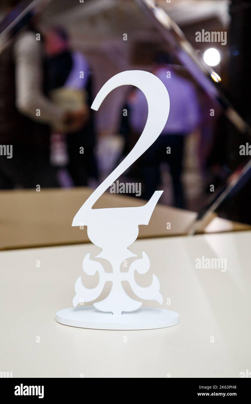 Numbers carved from wood on a stand Stock Photo - Alamy