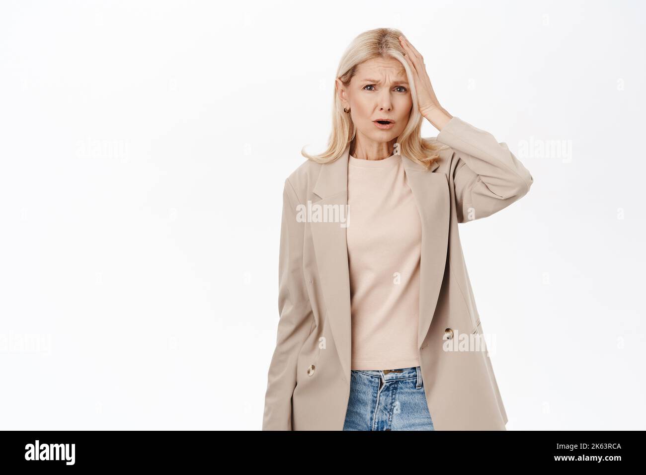 Portrait of mature lady looks confused, gasping and looking worried ...