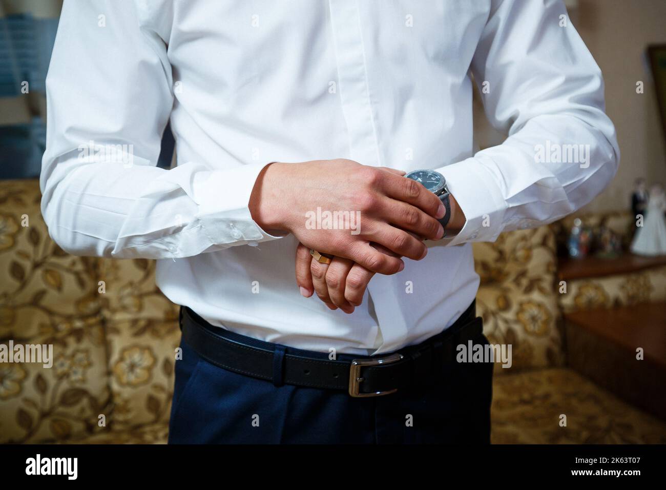 man puts a watch on his hand Stock Photo - Alamy