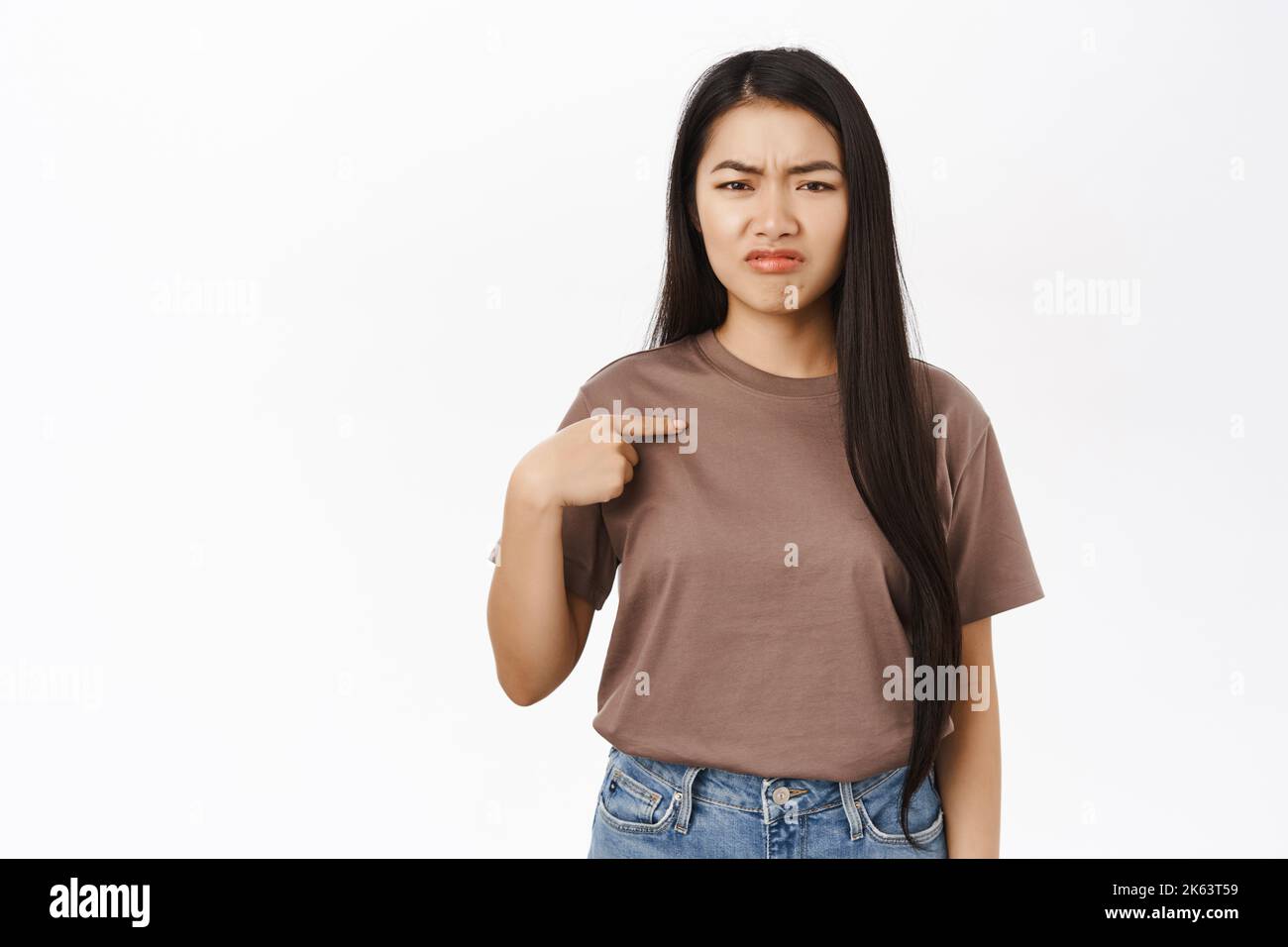 Sad asian woman pointing at herself, sulking and grimacing upset, being ...