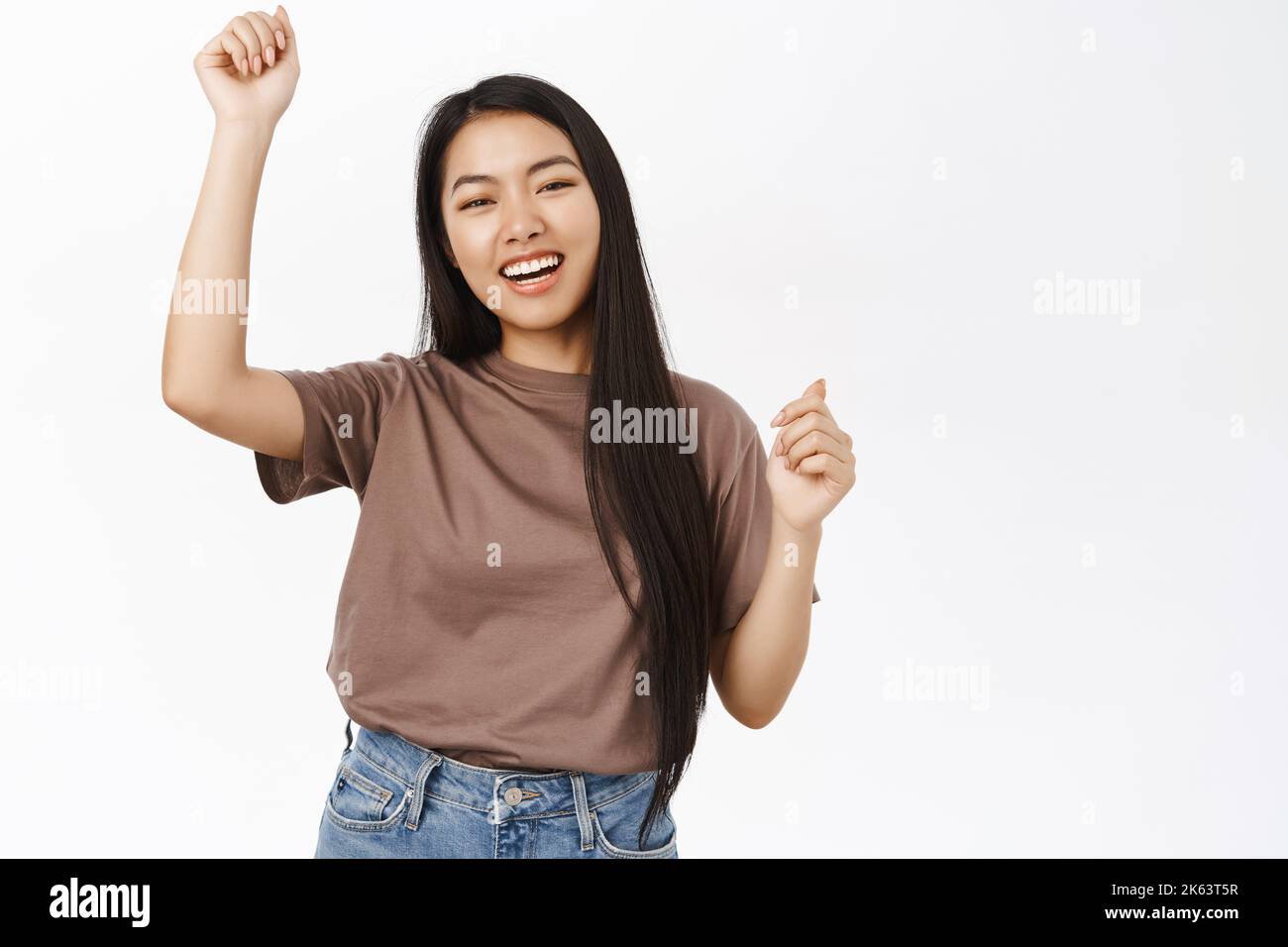 Happy dancing asian girl, celebrating and triumphing, winning and ...