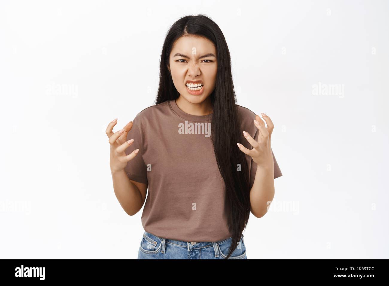 Angry asian teen girl shakes hands, grimacing outraged, furious ...