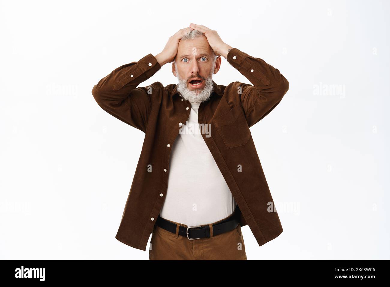 Senior man in panic, holding hands on head anxious, looking worried ...