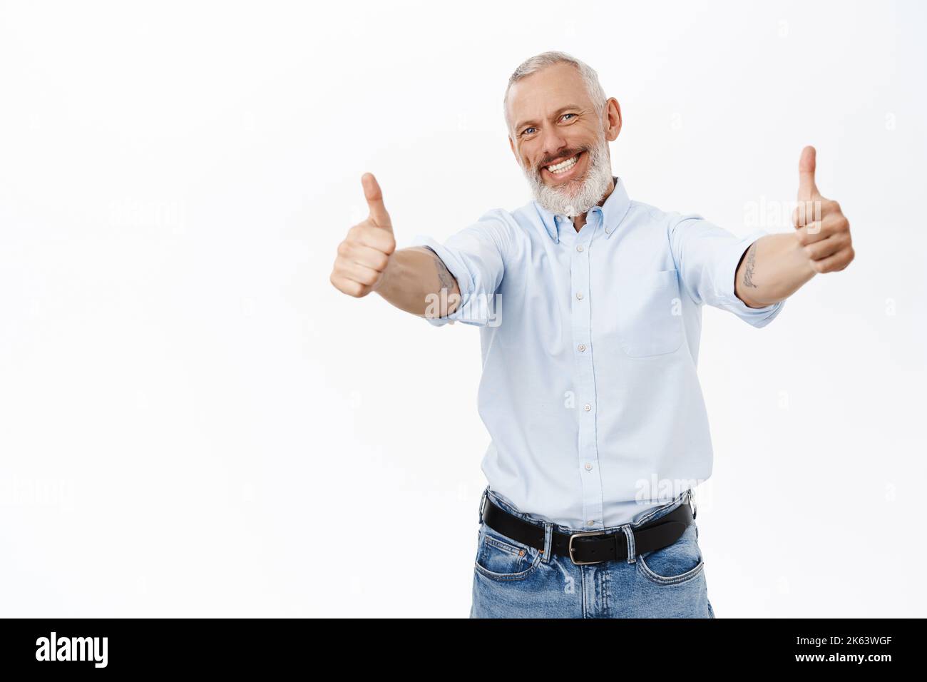 Smiling cheerful businessman, senior guy showing thumbs up in approval ...