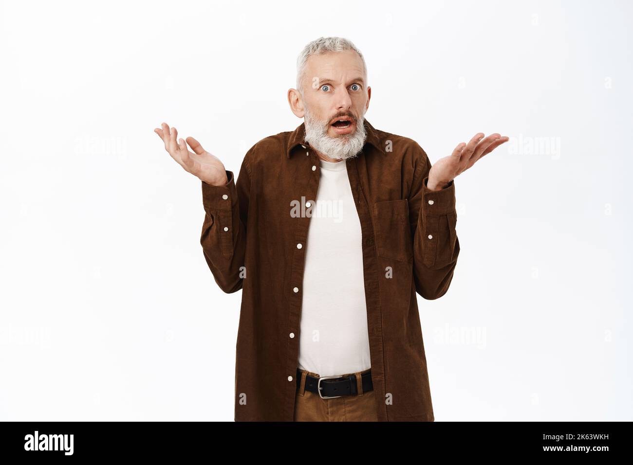 Surprised old man, senior caucasian guy shrugging shoulders and looking ...