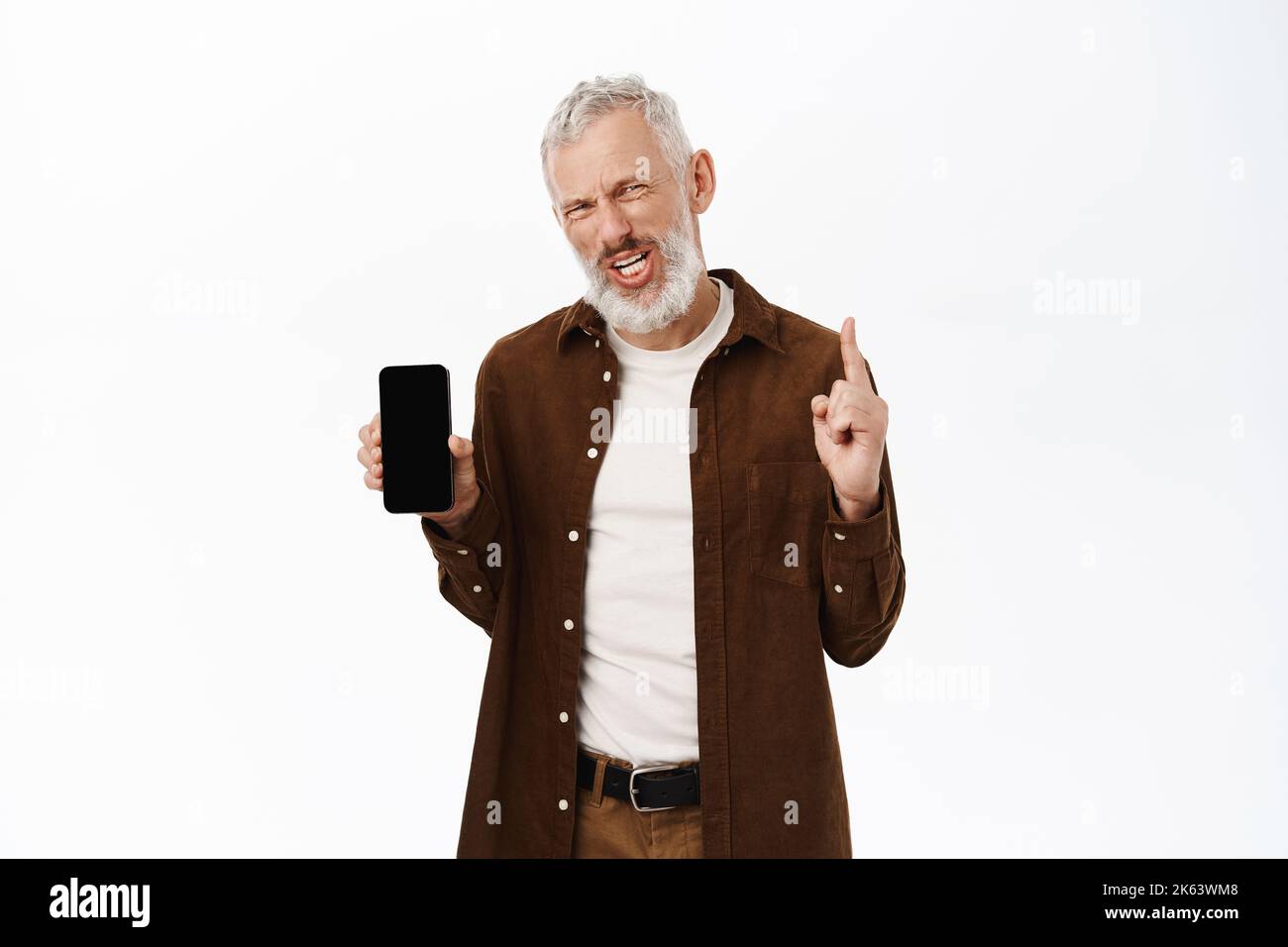 Portrait of senior man, old caucasian guy showing mobile phone screen ...