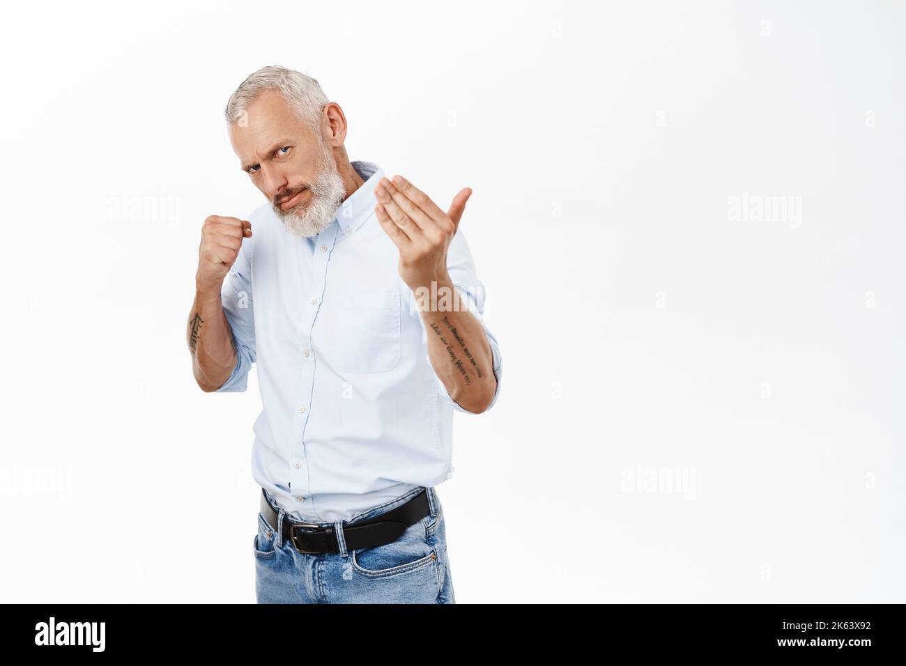 Image of serious senior man in shirt, clench fist and lure to come ...