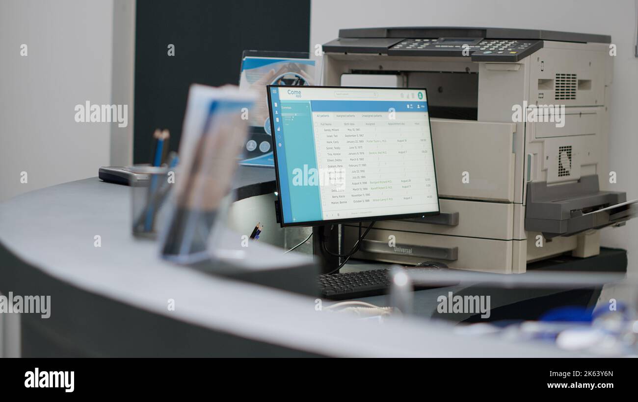 Hospital reception desk with medical appointments on computer to help ...