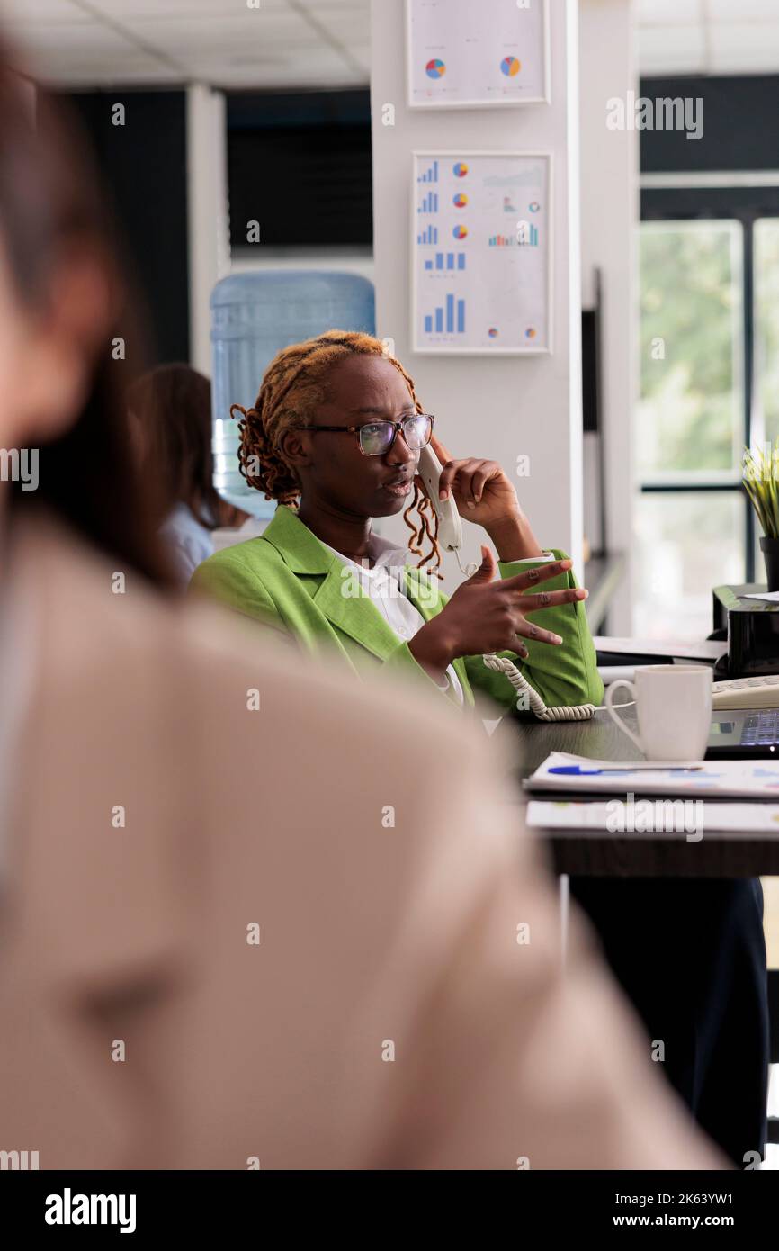 Employee discussing company financial strategy with business partners ...