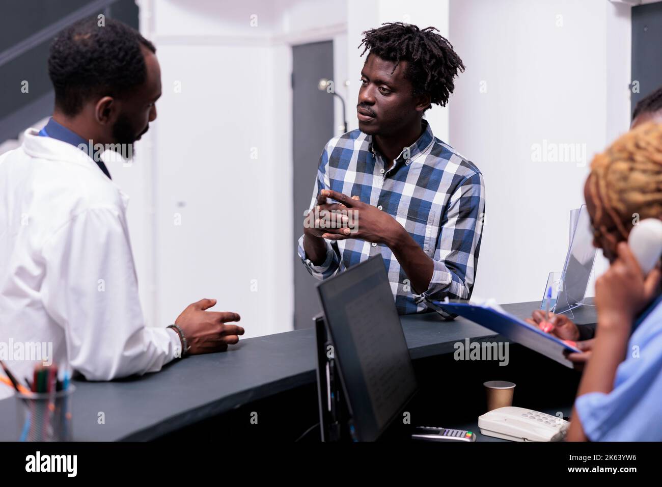 African american patient and doctor talking about disease diagnosis at ...