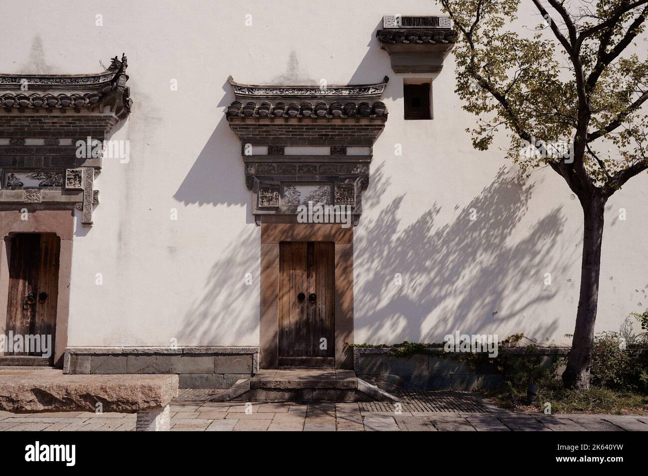 Traditional classic Chinese wooden doors and white exterior wall of an ...