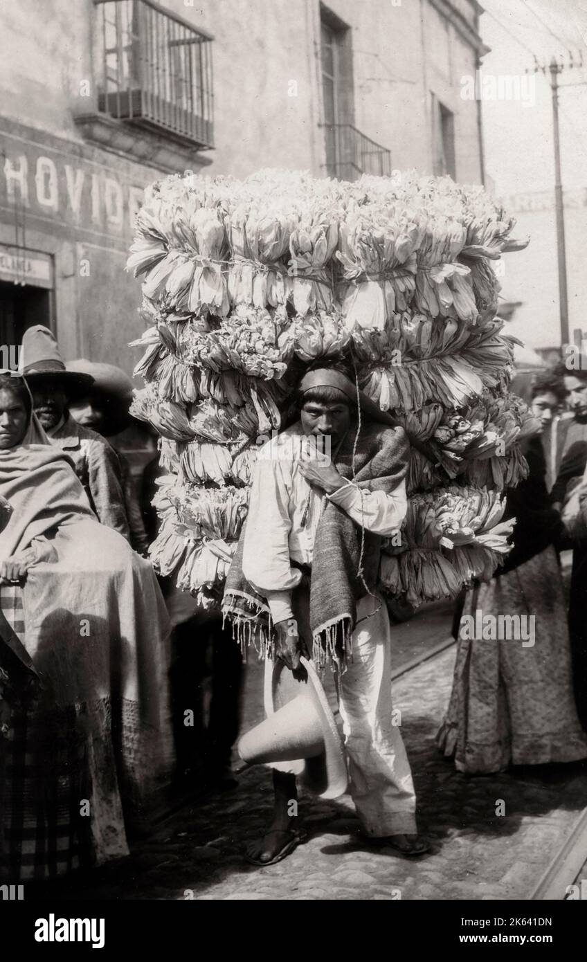 Vintage 19th century photograph: Porter carrying corn husks used for ...