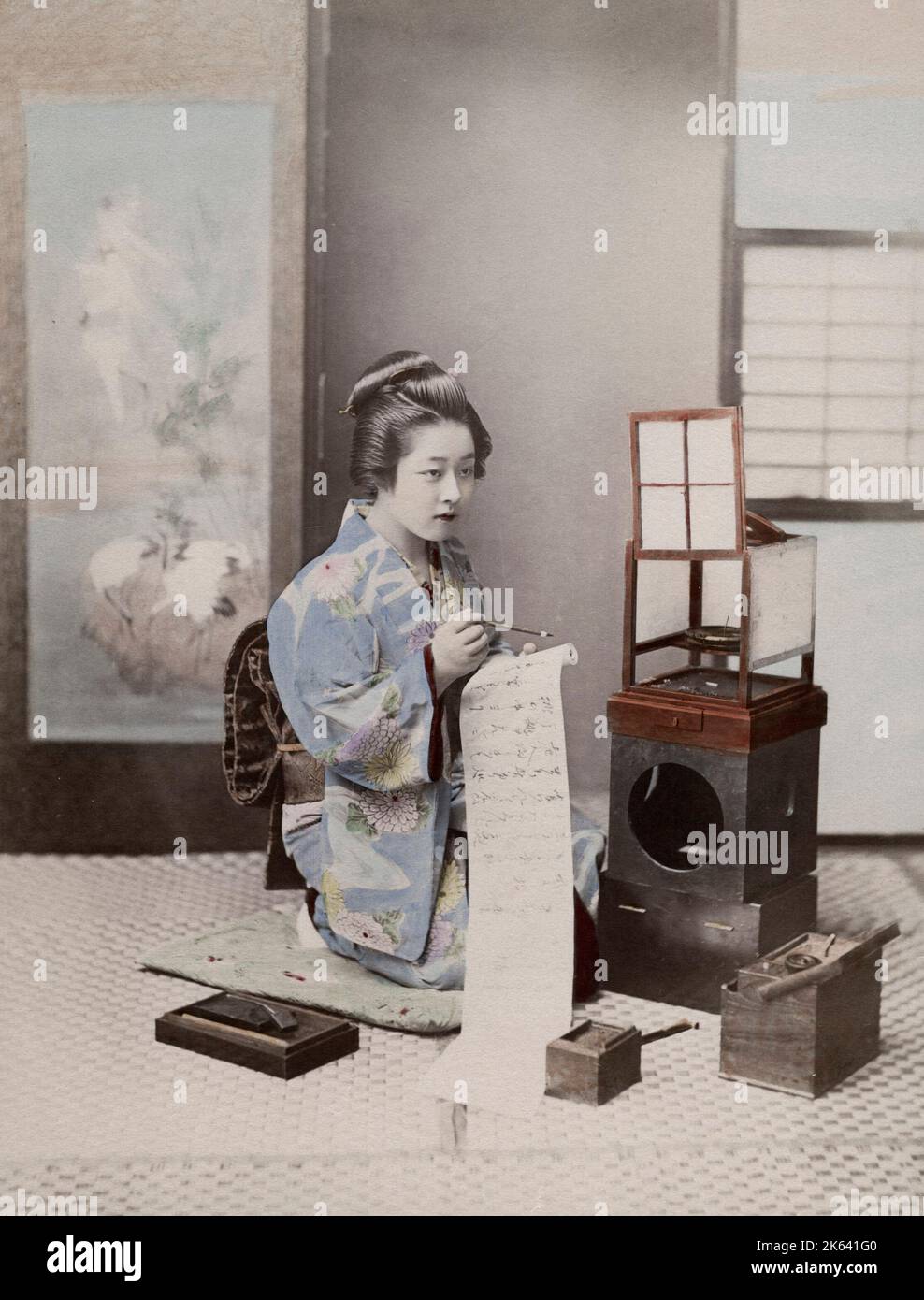 Japanese geisha in an ornate kimono writing a letter. Vintage 19th ...