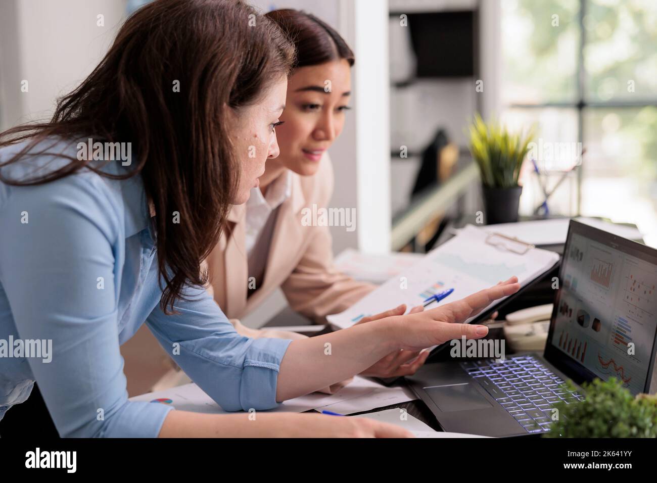 Start up company employees analyzing financial report statistics ...