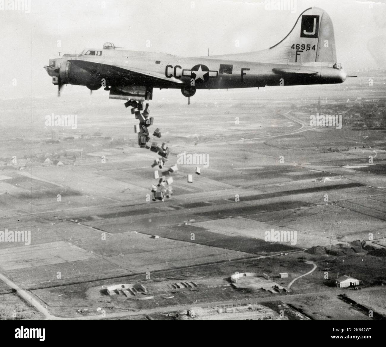 World War II vintage photograph - B-17 Flying fortress makes food drop ...