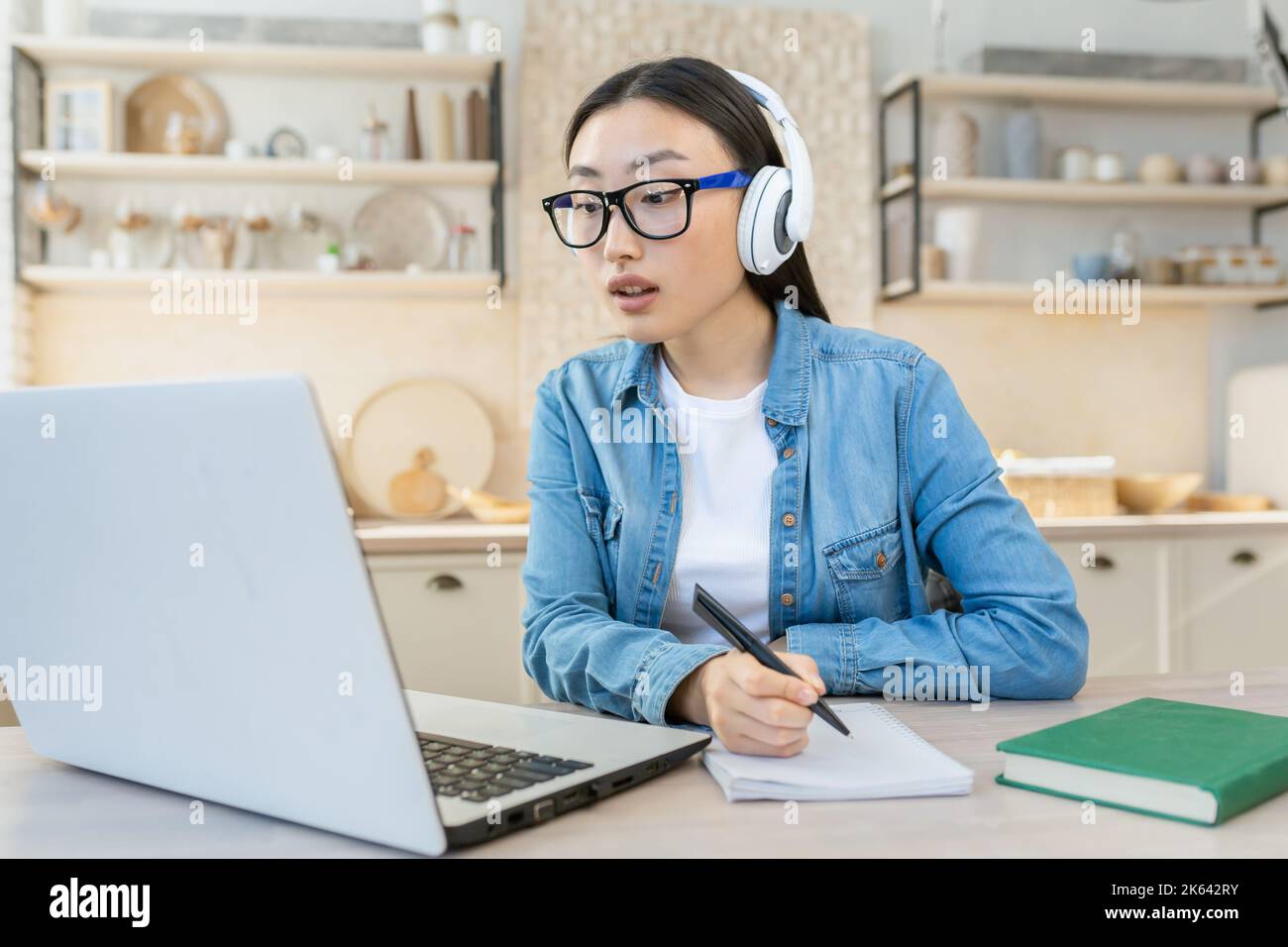 Young asian student studying at home remotely, woman watching online ...