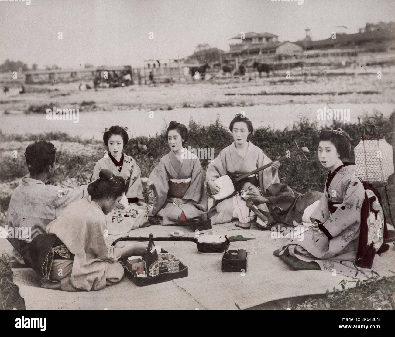 Group of geishas musicians on a picnic with a man, Japan, late 19th ...