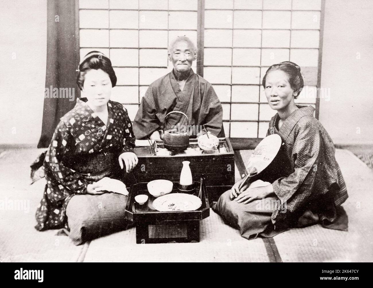 1870's Japan - 'a domestic group - taking tea around a stove - from ...