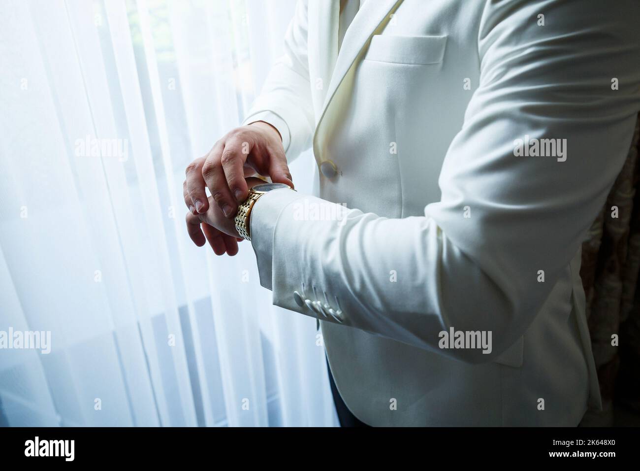 man puts a watch on his hand Stock Photo - Alamy