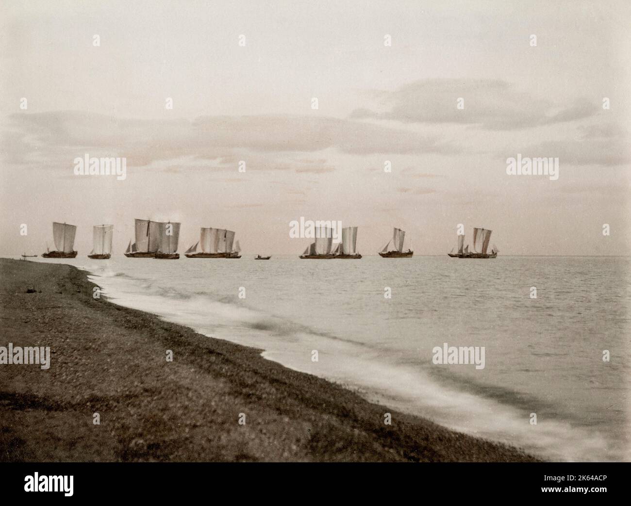 Vintage 19th century photograph: group of ships, boats sailing offshore ...