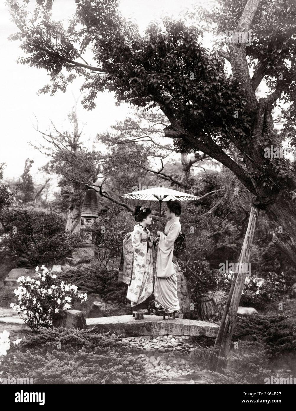 Two geishas under a parasol, Japan, c.1890 Stock Photo - Alamy