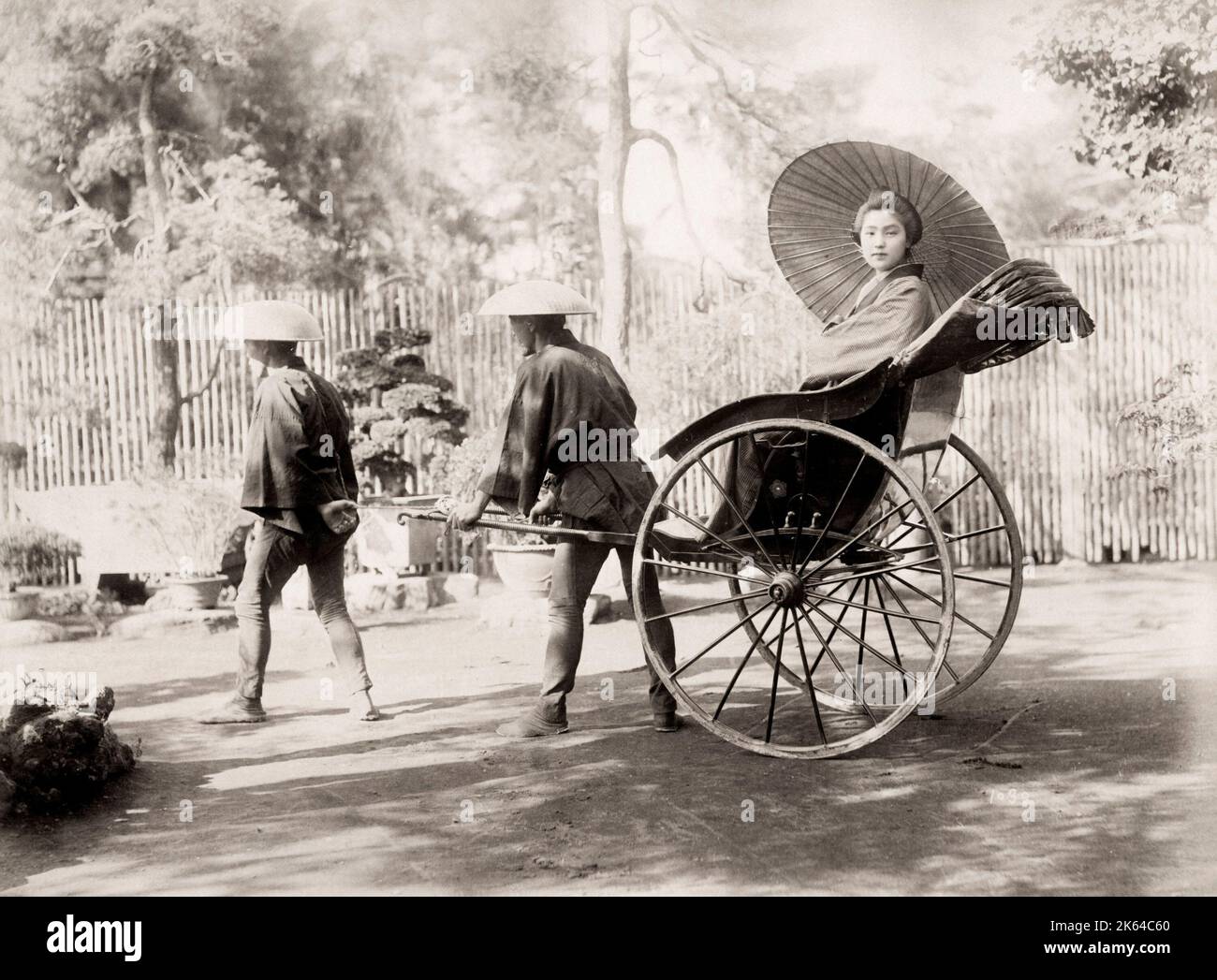 Vintage 19th century photograph: young woman in a rickshaw, jinrikisha ...