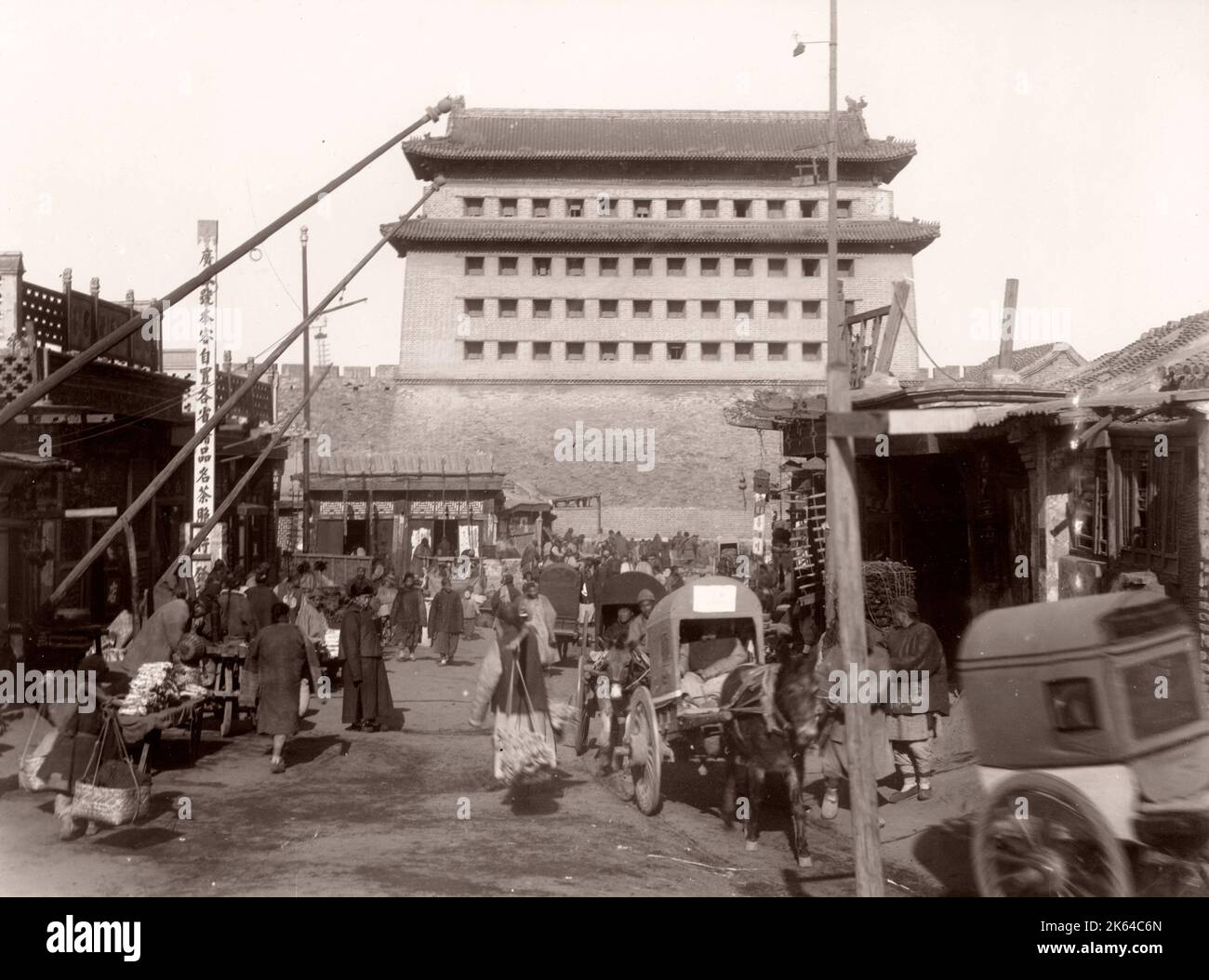 Late 19th century vintage photograph: City gate and busy street, Peking ...