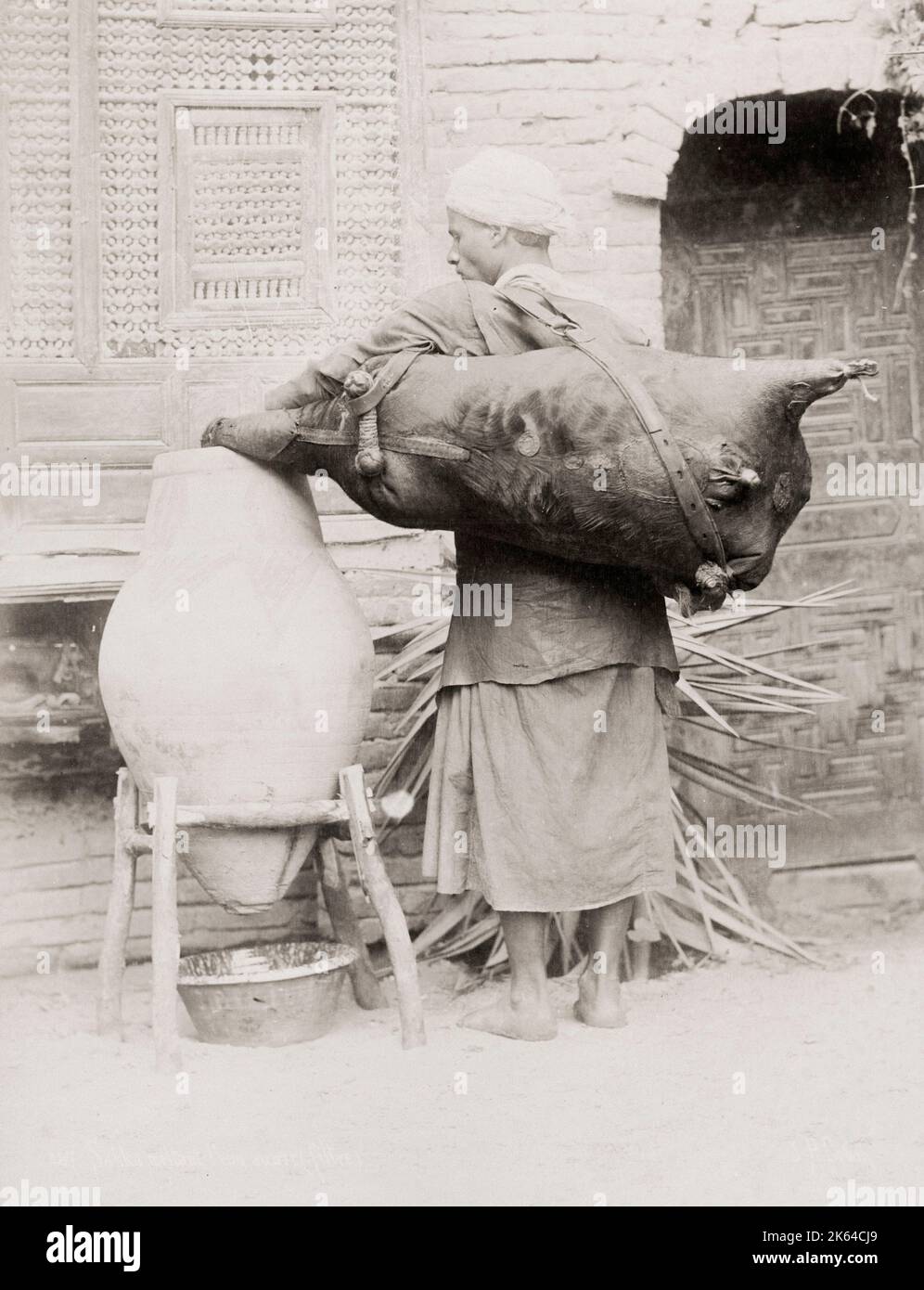 Vintage 19th century photograph - water carrier with an animal skin ...