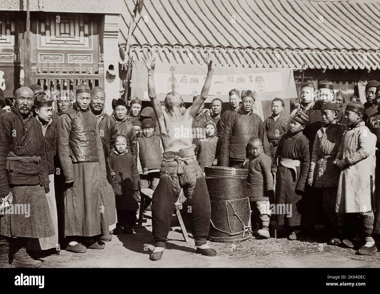 Early 20th century photograph: Chines man swallowing a sword, street ...