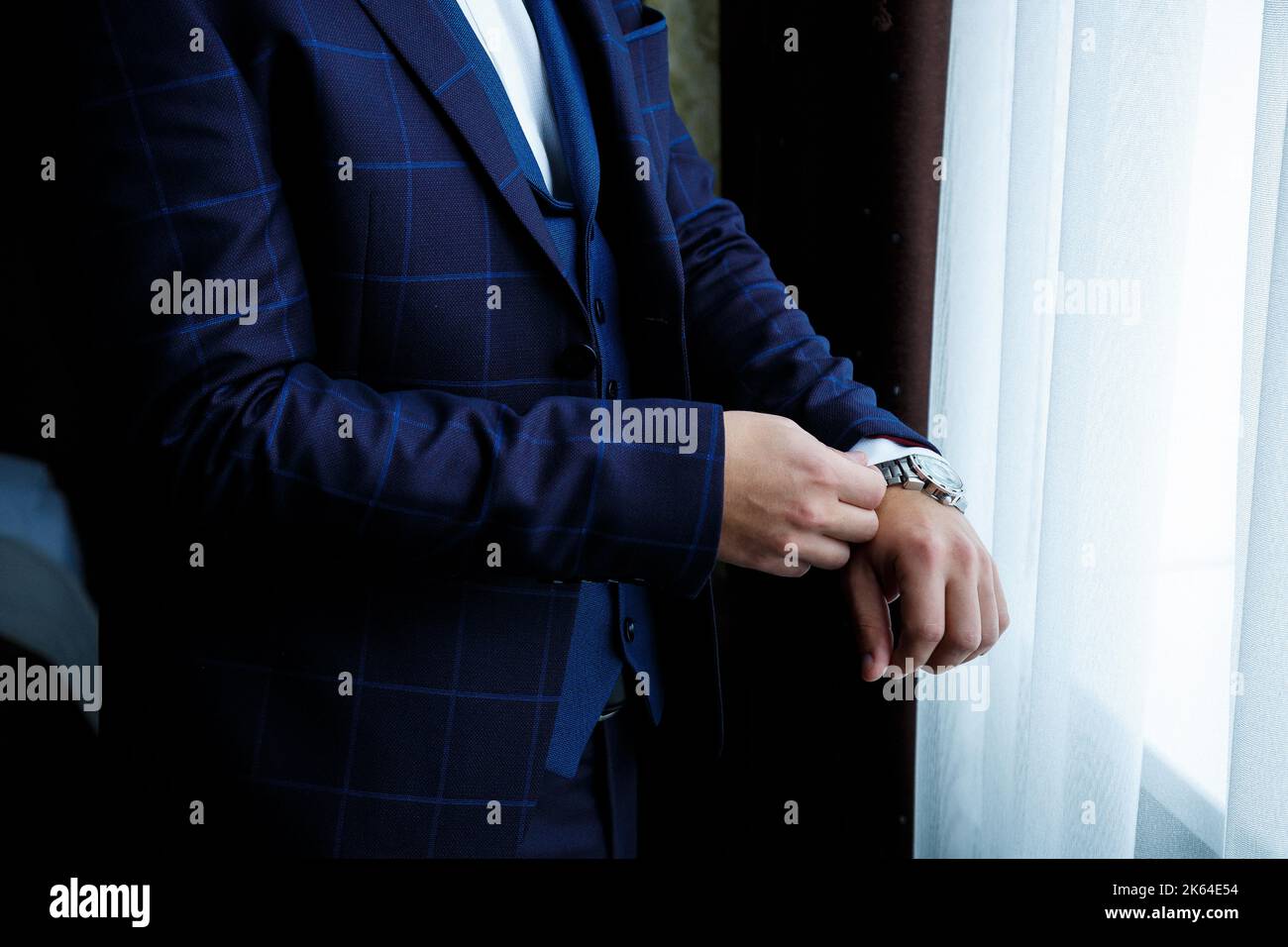 man puts a watch on his hand Stock Photo - Alamy