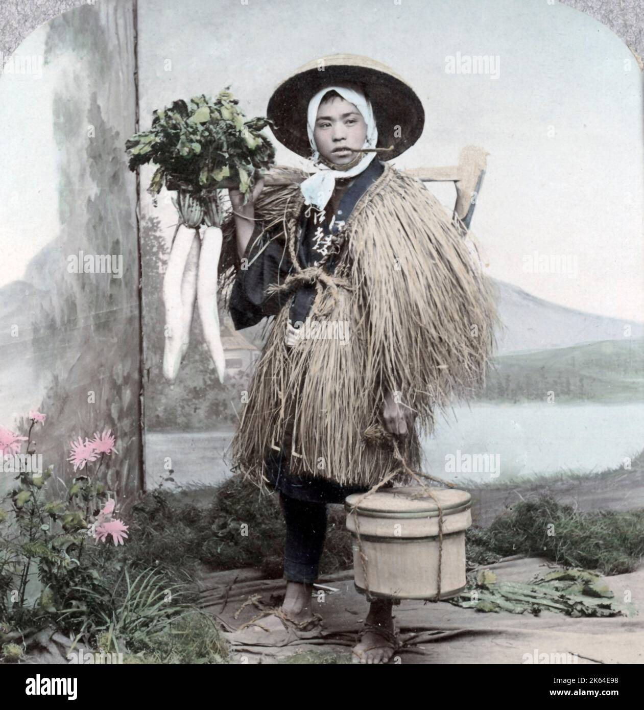 Farm labourer with grass coat and vegetables, Japan, c.1900 Stock Photo ...