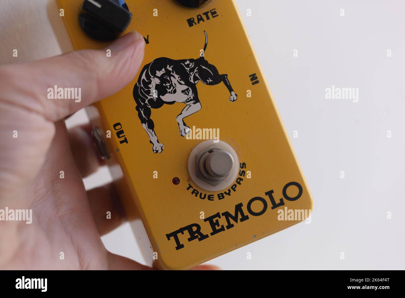 Close-up of a hand holding a Tremolo effects box ( music equipment ...