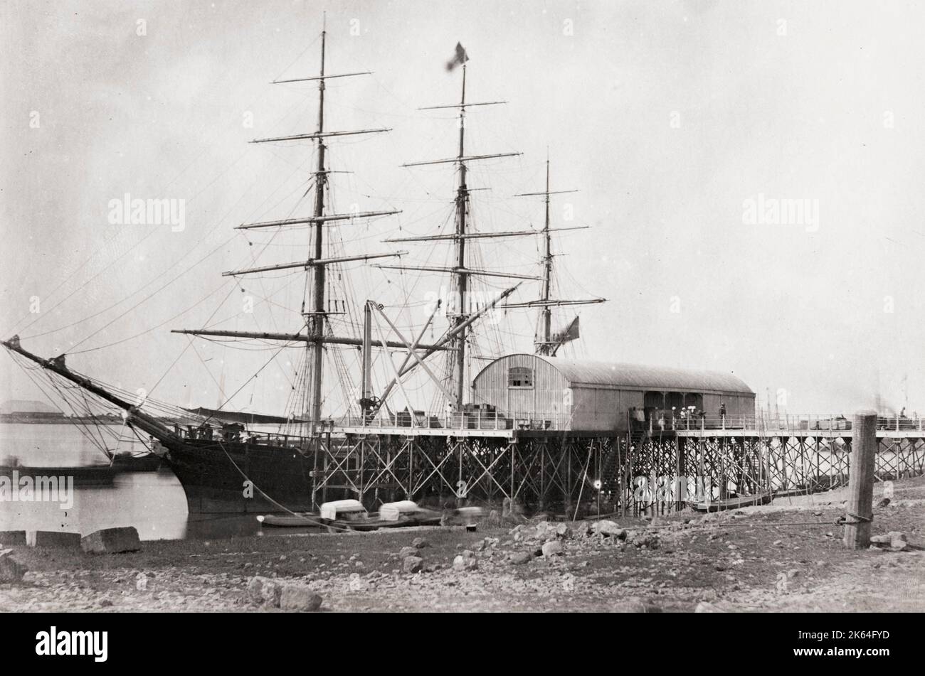 Vintage 19th century photograph: ship at iron wharf, scaffolding ...
