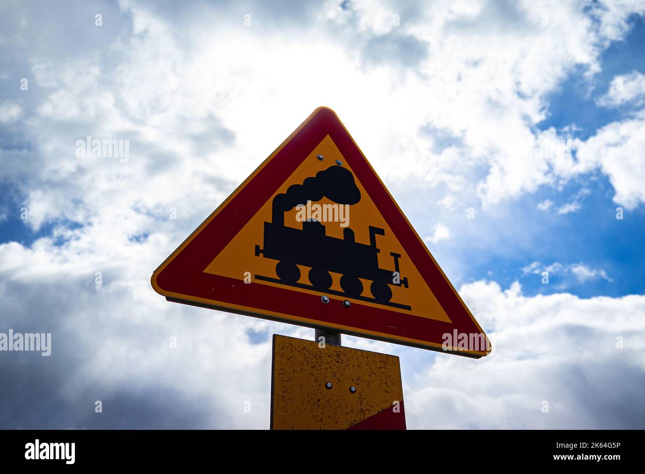 A street "Train warning" sign against the blue sky Stock Photo - Alamy