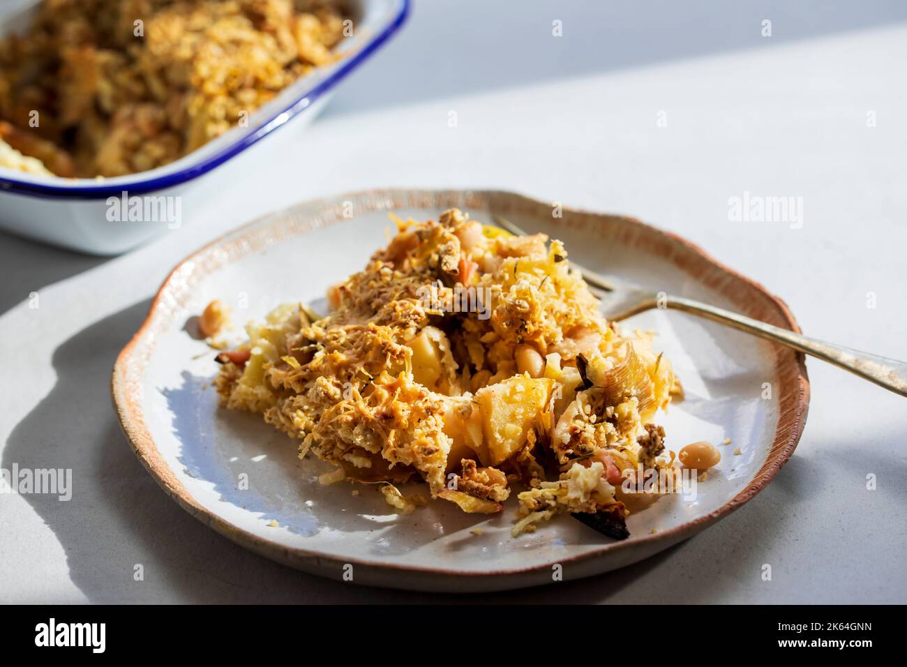 Vegan dish of parsnip, leek and bean crumble with crispy topping Stock ...