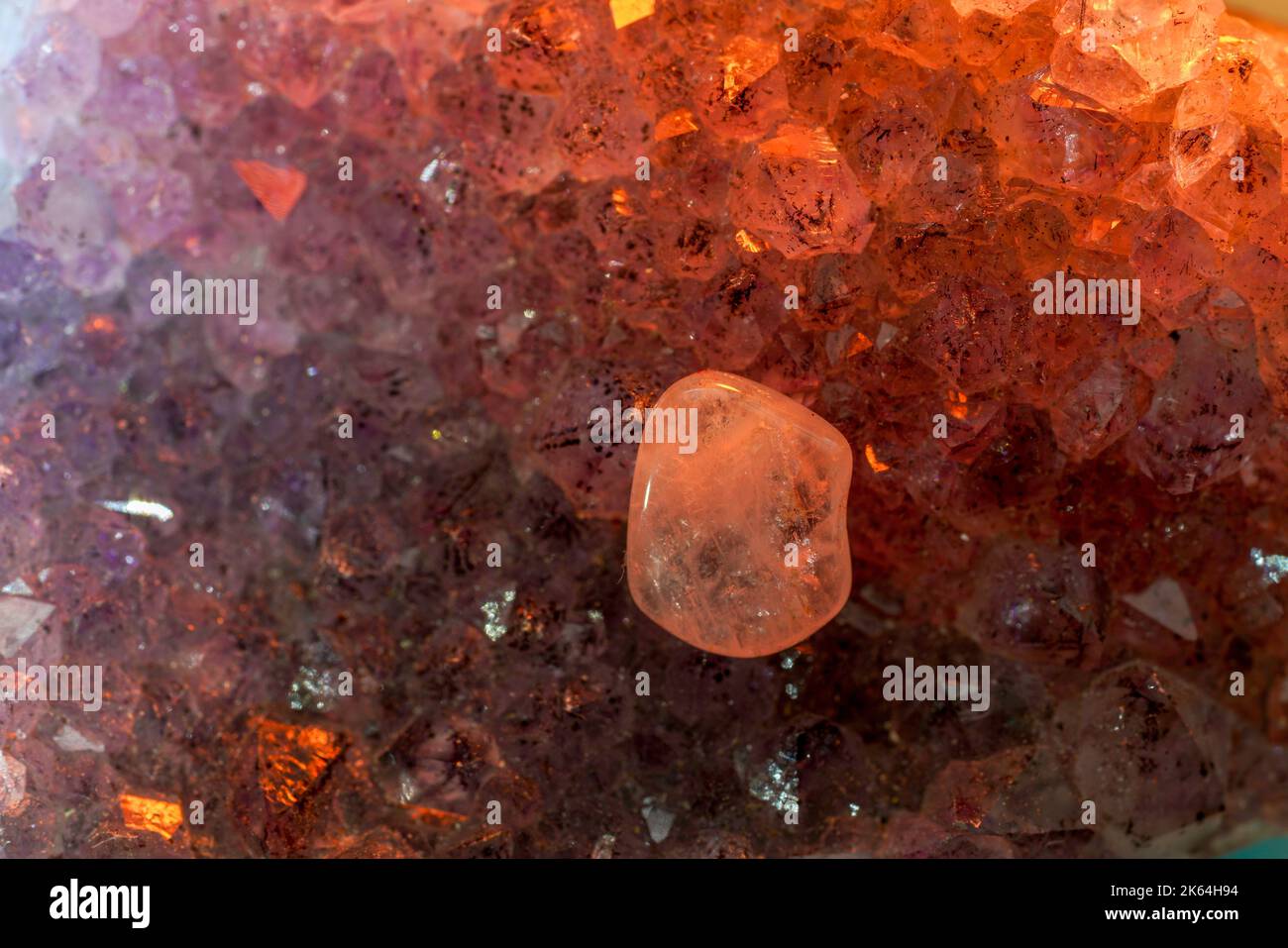A closeup shot of a red textured crystal rock with a white round on set ...