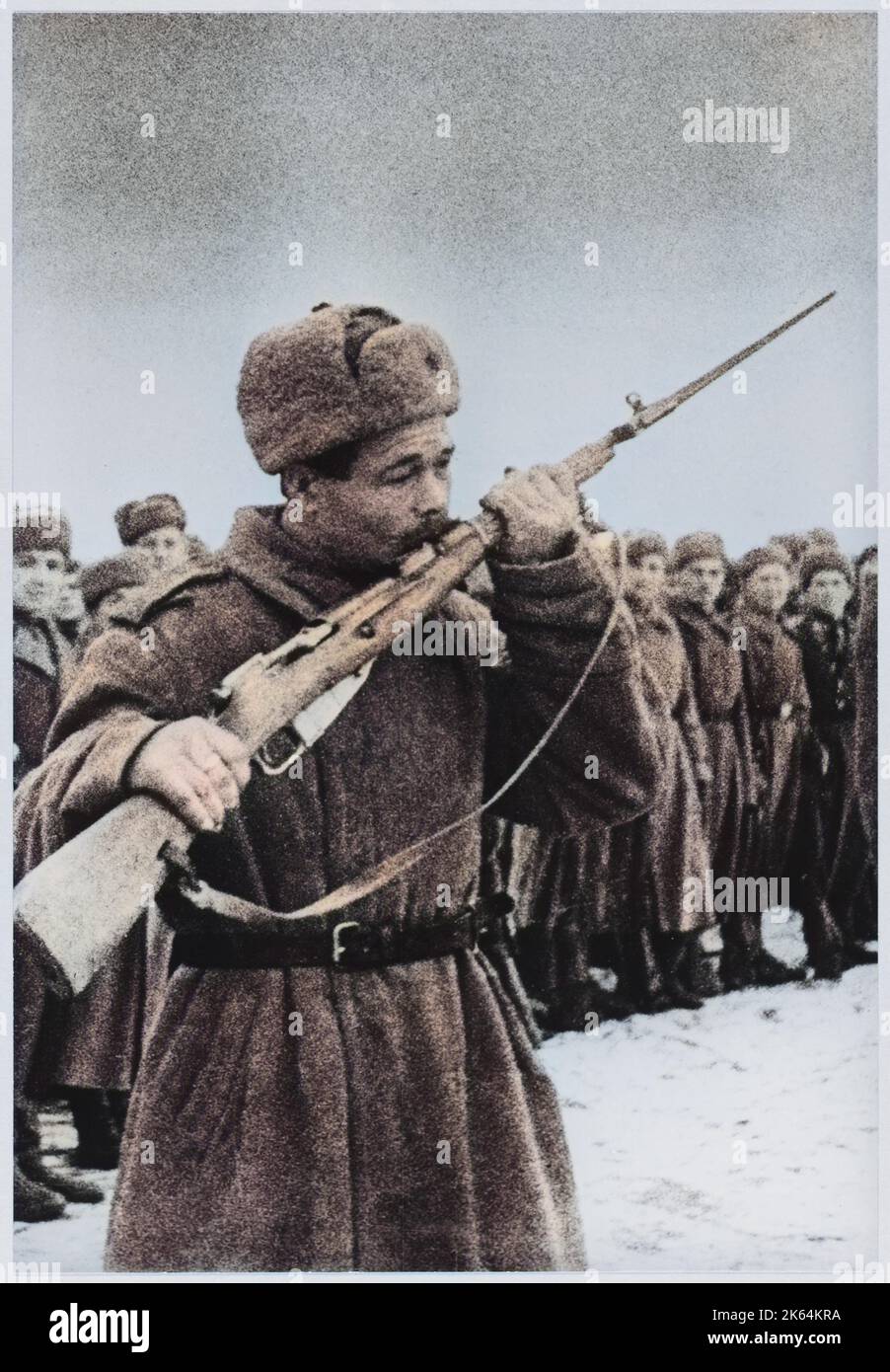 A Soviet soldier makes the 'Soldiers' Oath', kissing his rifle Stock ...