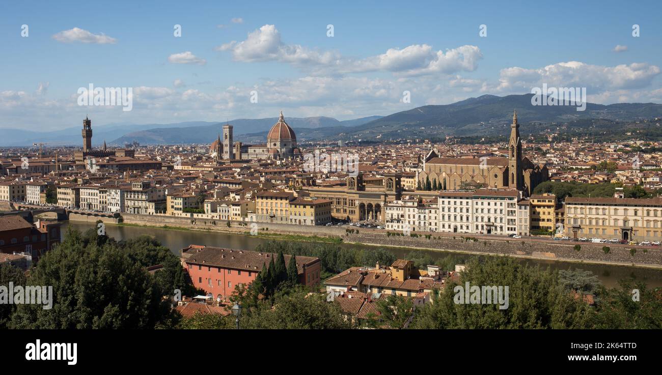An aerial view of the city of Florence with a beautiful mountain on the ...