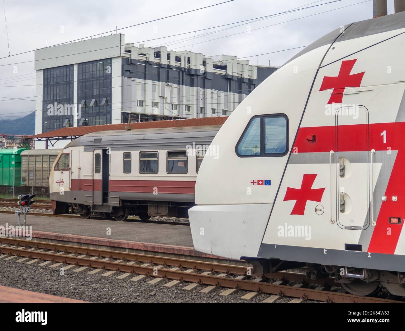 Passenger train at the station. Passenger transportation. At the pier ...