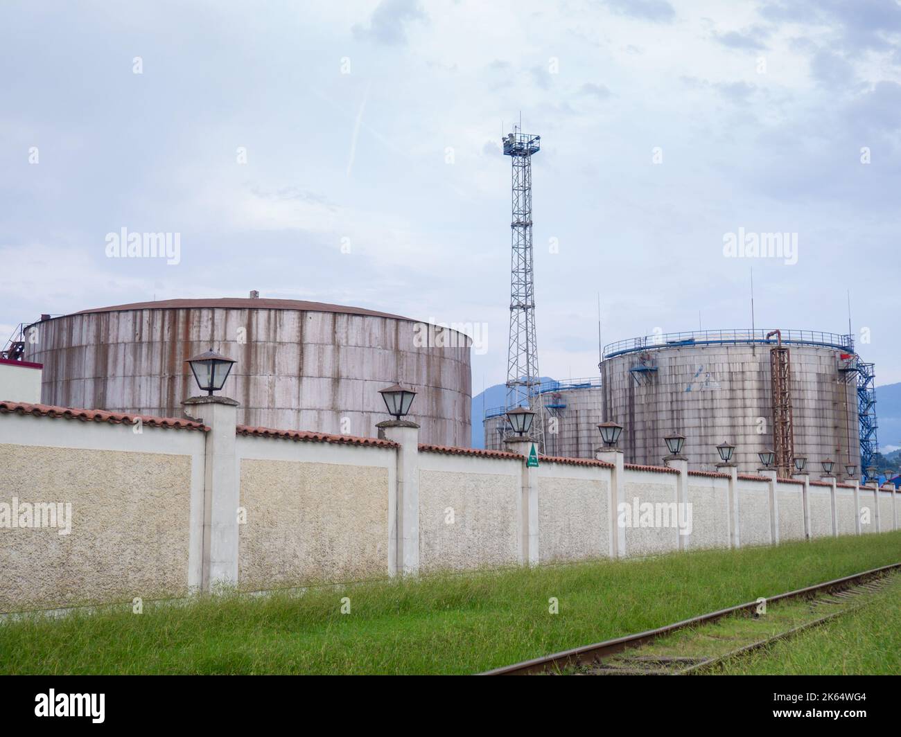 Large fuel tanks. Tanks and ladders of the tank farm. The gloomy ...